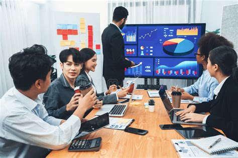 Businessman Presenting Data Analysis Dashboard On Tv At Meeting Room