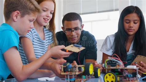 Students With Male Teacher In School Computer Class Building And