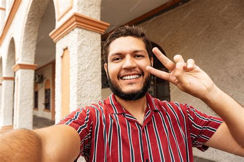 Premium Photo Hispanic Young Man Taking A Selfie