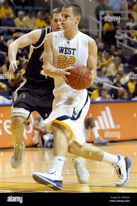 West Virginia Guard Alex Ruoff 22 Drives The Lane As Providence Guard