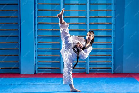 Premium Photo Young Sport Woman Practicing Martial Art Of Taekwondo