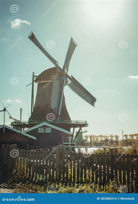 Scenic View Of Two Windmills Standing In A Small Sunny And Rural Area