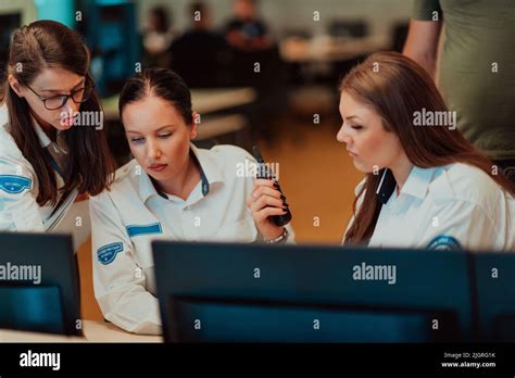Group Of Female Security Operators Working In A Data System Control Room Technical Operators
