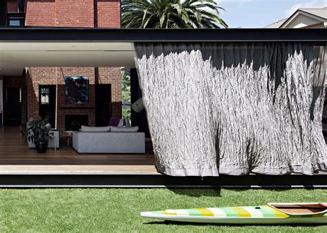 Free Flowing And Kinetic Metal Mesh Curtain Wraps Around Extension To Melbourne House