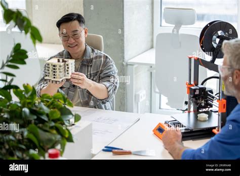 architects making house model working with 3d printer creating process