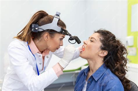 Premium Photo Female Patient Opening Her Mouth For The Doctor To Look In Her Throat