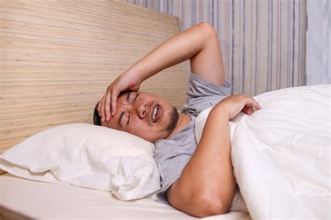 Premium Photo Asian Man Woke Up On Bed With Headache Or Migraine