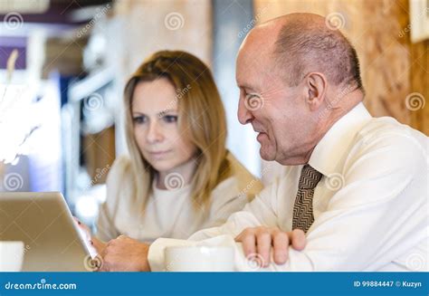 Young Adult Personal Assistant And Senior Ceo Work Together Stock Image