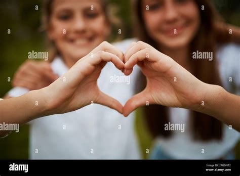 I Love My Sister Closeup Shot Of Two Young Sisters Hands Making A