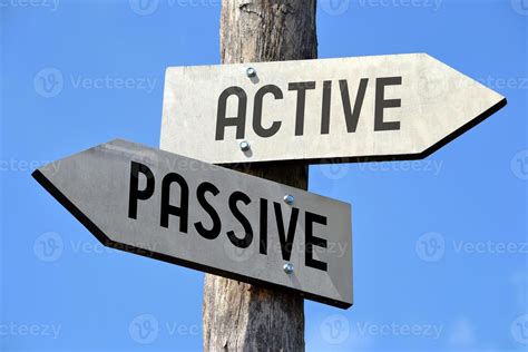 Active And Passive Wooden Signpost With Two Arrows 21592697 Stock