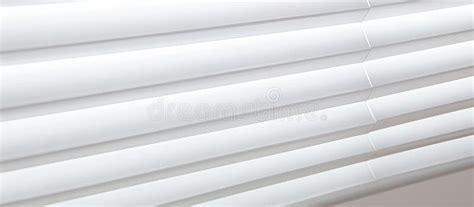 A Close Up Of A Grey Rectangular Blind On A Window With Wood And Metal Accents Stock