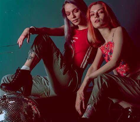 Premium Photo Twins Sisters In Joggers And Red Tops