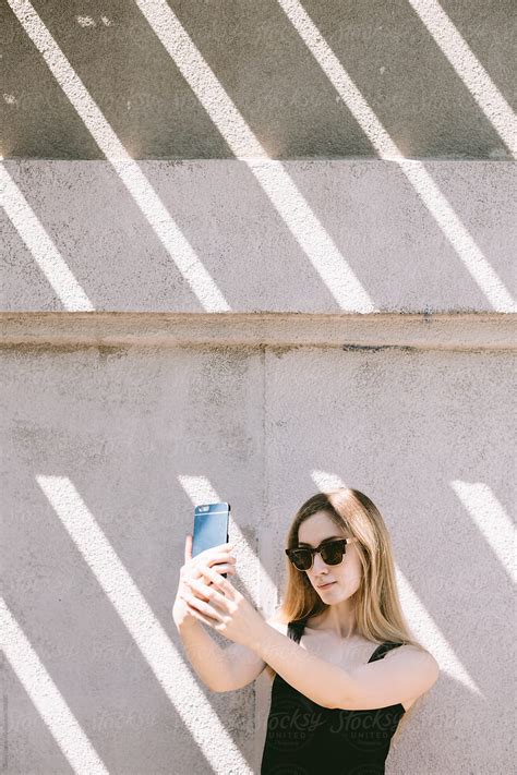 Young Woman Taking A Selfie With Cell Phone By Stocksy Contributor