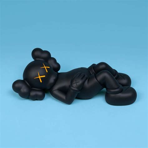 Download Black Kaws Figure Lying Down Wallpaper