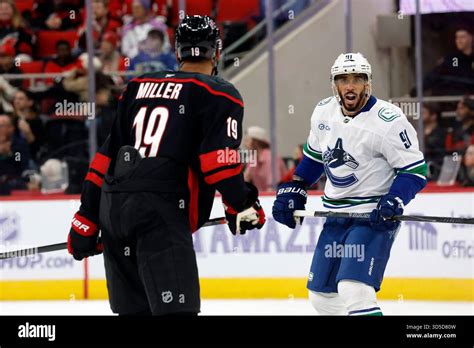 Carolina Hurricanes Kandre Miller 19 Chirps At Vancouver Canucks Evander Kane 91 During
