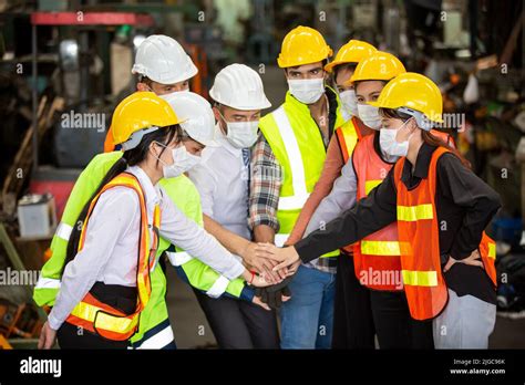 Architect Civil Engineer And Worker Looking At Plans And Blueprints
