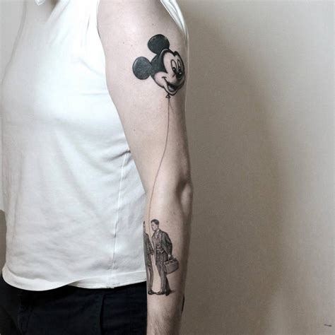 Dandies Holding A Mickey Mouse Balloon Tartooed On The