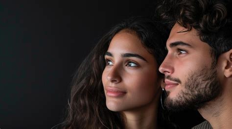 Premium Photo A Man And A Woman Are Looking At Each Other And One Has