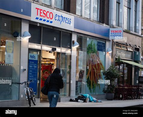London Uk Tesco Express Shop In Central London With Homeless Man