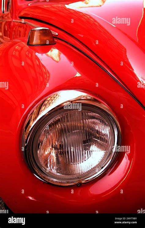 Detail Of The Round Headlight Of A Red Car With Rounded Lines Stock