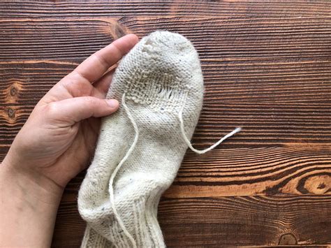 A Partially Mended Sock Using The Traditional Method Of Darning Hand