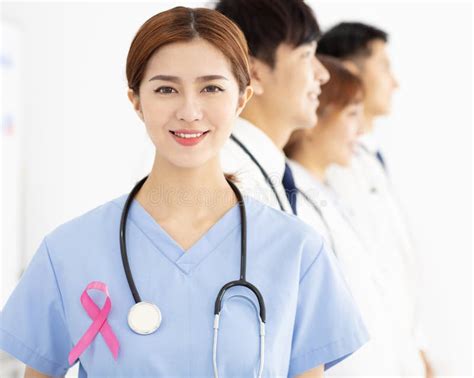 Medical Team With Pink Breast Cancer Awareness Ribbon Stock Image