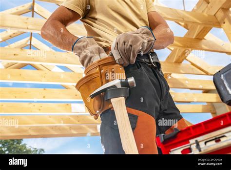 A Construction Worker Is Adjusting His Tool Belt Readying Essential