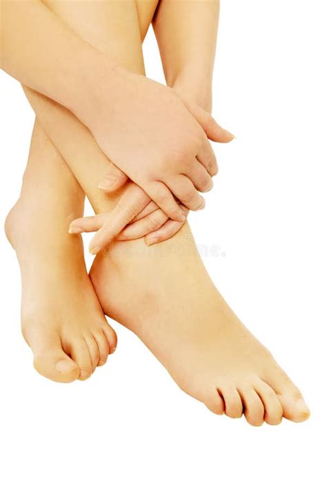 Young Naked Woman Sitting On The Floor And Touching Her Foot Stock