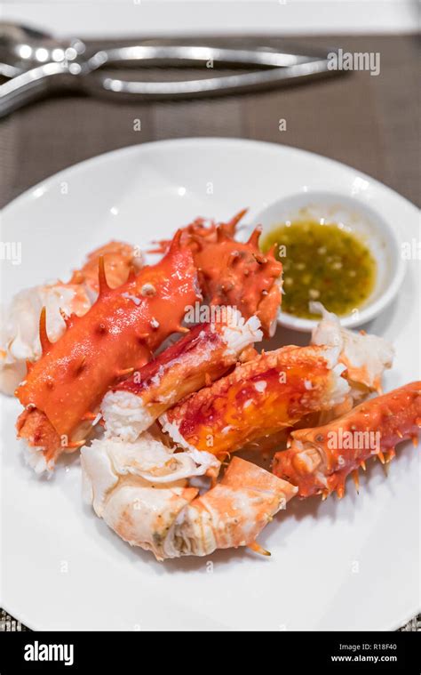 Alaskan King Crab And Seafood On White Dish With Seafood Sauce Stock