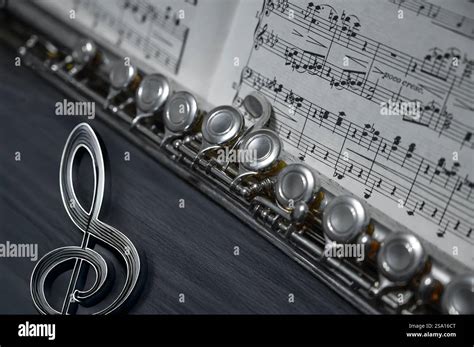 For The Love Of Music A Treble Clef Accompanied By A Transverse Flute And Musical Notes Stock