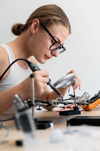Premium Photo Young Female Inventor Creating In Her Workshop