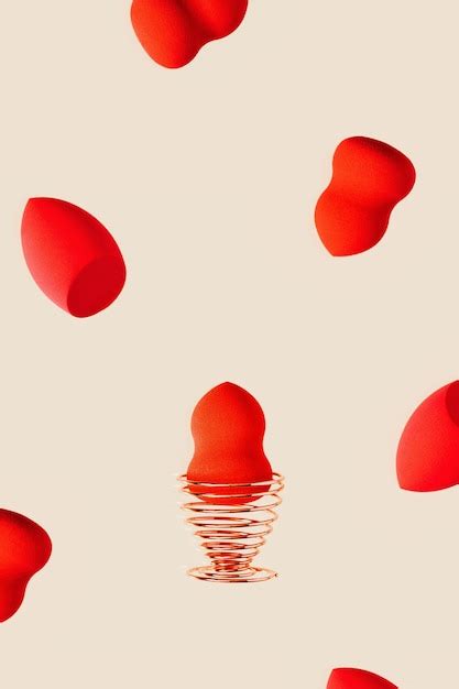 Premium Photo Cosmetic Sponge Red Colored In Stand On Beige