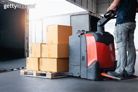 Workers Unloading Package Boxes Into Container Truck Forklift Pallet Jack Loading Dock