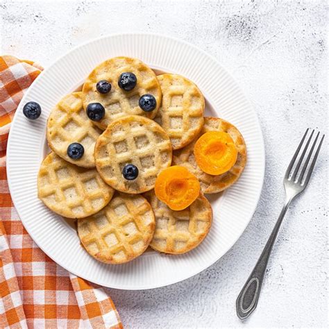 Premium Photo Small Round Waffles And Fruits On Grey Background Flat Lay