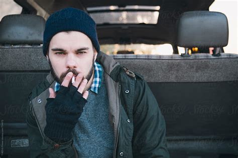 Man Sitting In His Minivan Smoking By Stocksy Contributor Danil