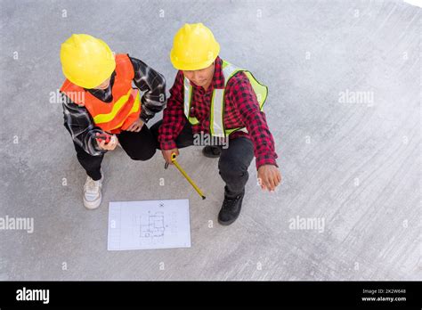 Architect And Client Discuss Help Create Plan With Blueprint Of The Building At Construction