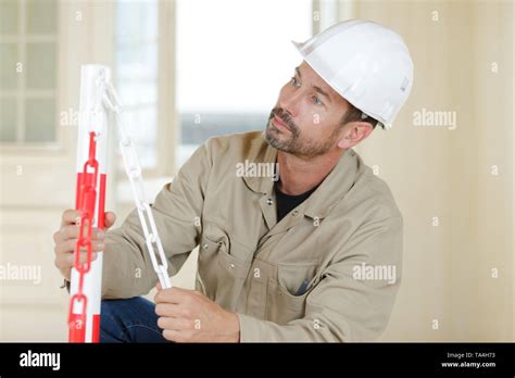 Builder Erecting Safety Chain Around Site Stock Photo Alamy