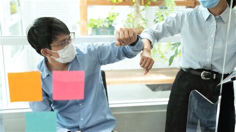 Premium Photo Colleagues Doing Elbow Bump In Office