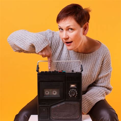 Free Photo Front View Senior Woman Holding Vintage Cassette Player