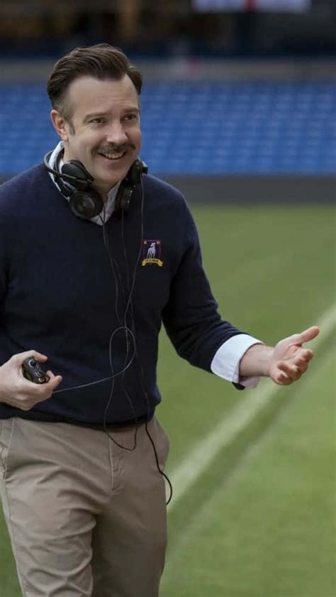 Download Ted Lasso Headphones Smile Stadium Wallpaper