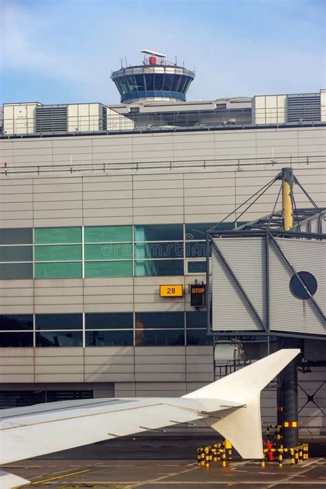 Airliner Wing Under The Airport Building With Control Tower Stock Image