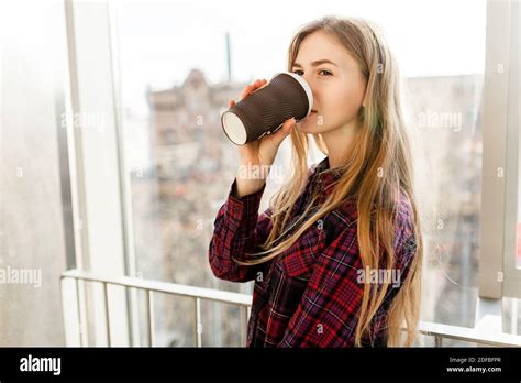 Young Beautiful Girl Drinking Coffee A Woman In An Office Building