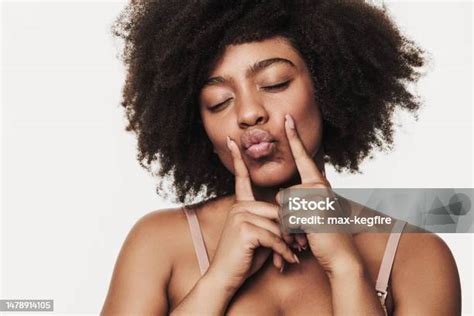 Happy Young Black Woman Pouting Lips Against White Background Stock