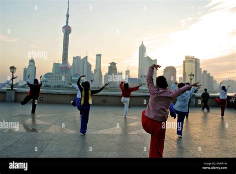 Women Team Doing Morning Exercise On The Bund Shanghai China Stock