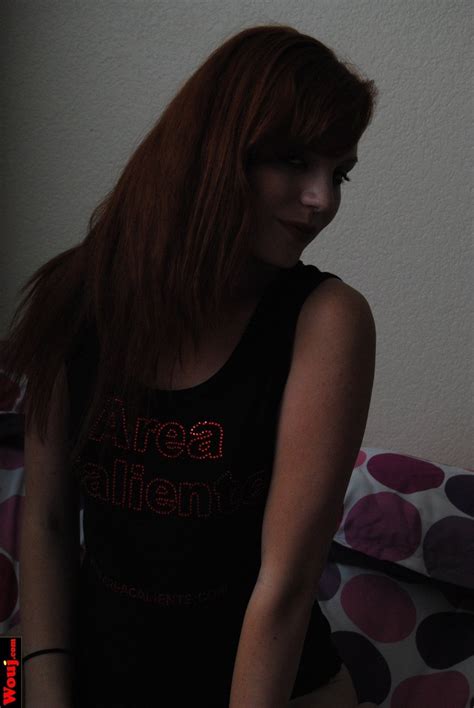 Redhead Cutie Showing Off Her Long Legs While Posing In A Black Shirt