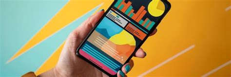 a hand holds a smartphone displaying colorful graphs charts and data