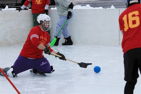 Download Broomball Player In Action From Red Team Wallpaper