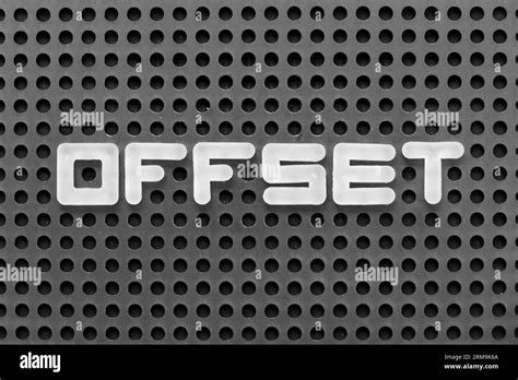 White Alphabet Letter In Word Offset On Black Pegboard Background Stock