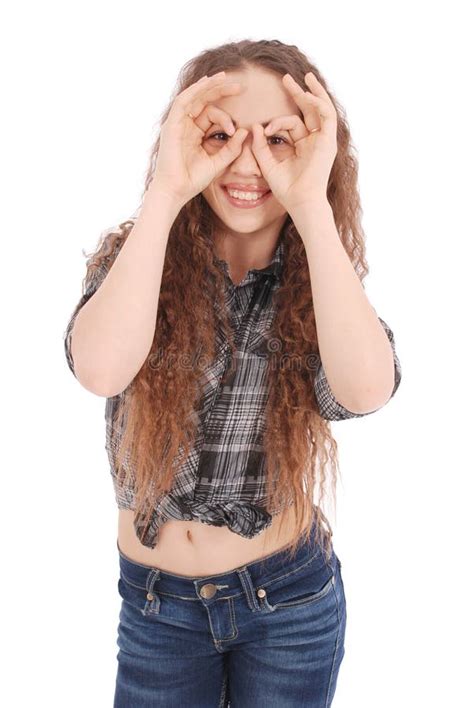 Portrait Of A Funny Young Girl Looking At Camera Through Fingers Stock