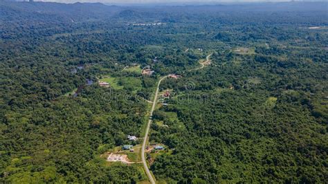 Aerial View Of Village Surrounded By Tropical Forest And Mountains Near Gunung Mulu National